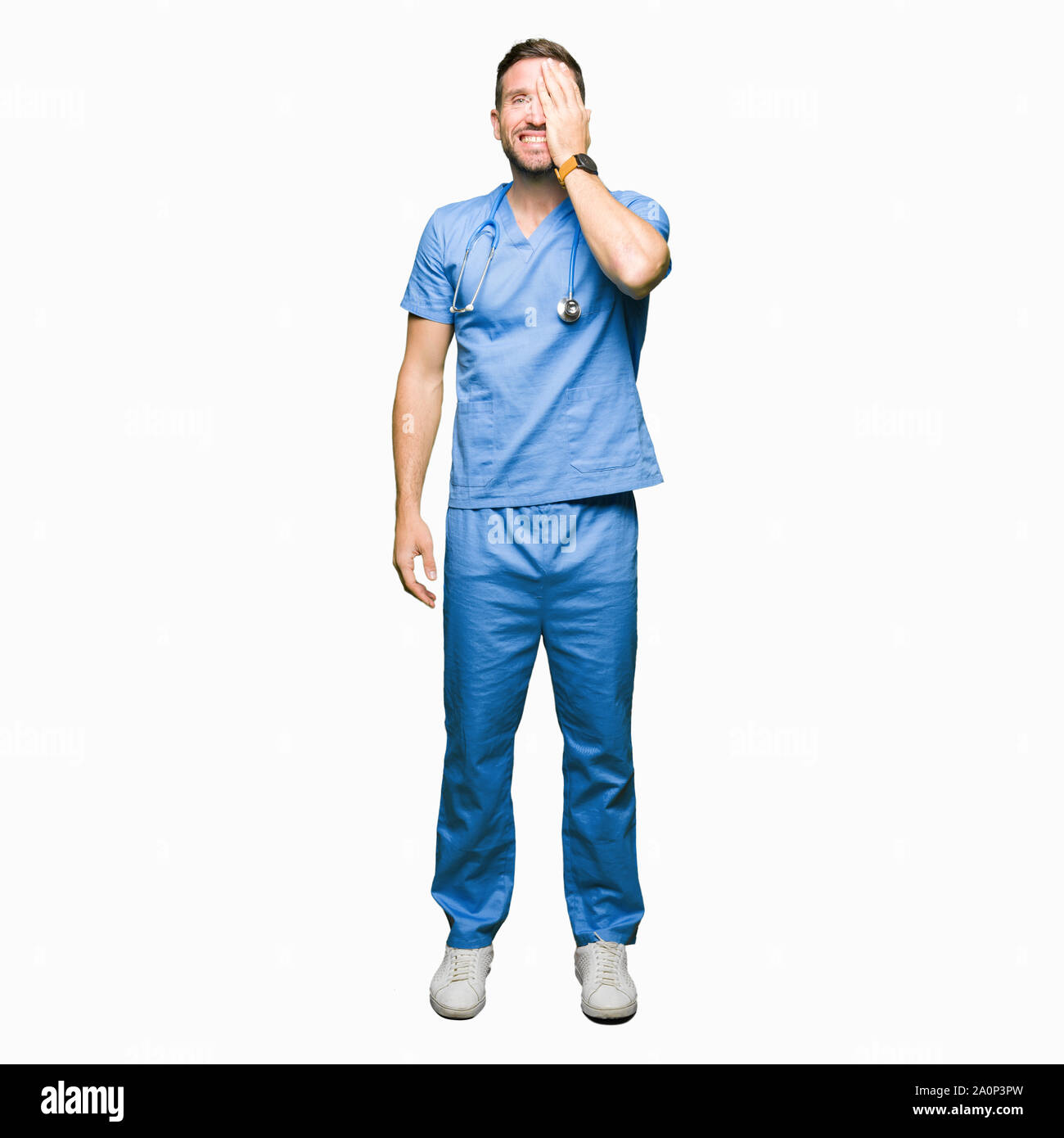 Handsome doctor man wearing medical uniform over isolated background ...