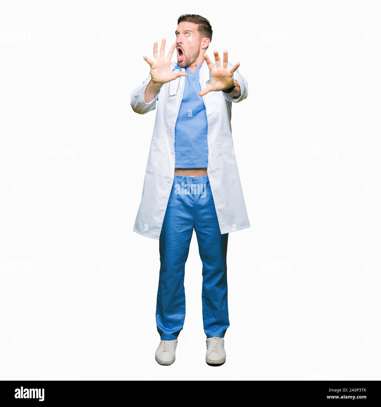 Handsome doctor man wearing medical uniform over isolated background ...