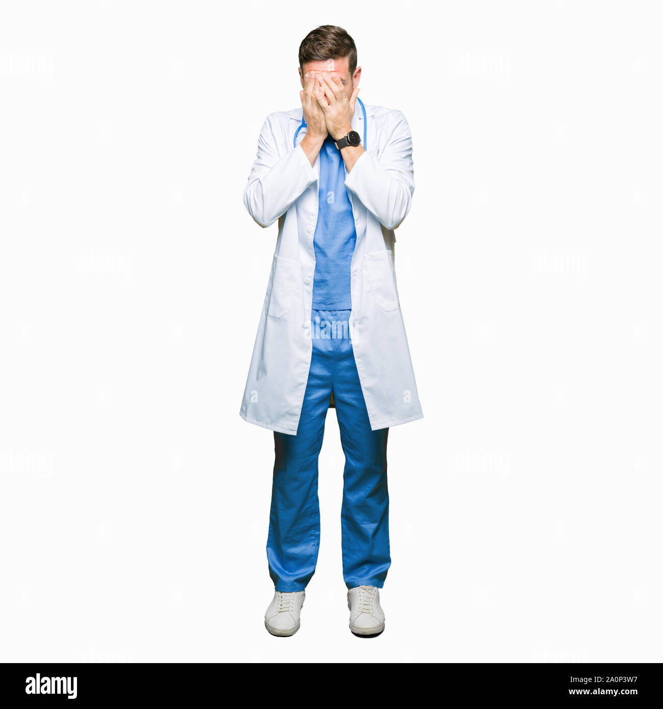 Handsome doctor man wearing medical uniform over isolated background ...