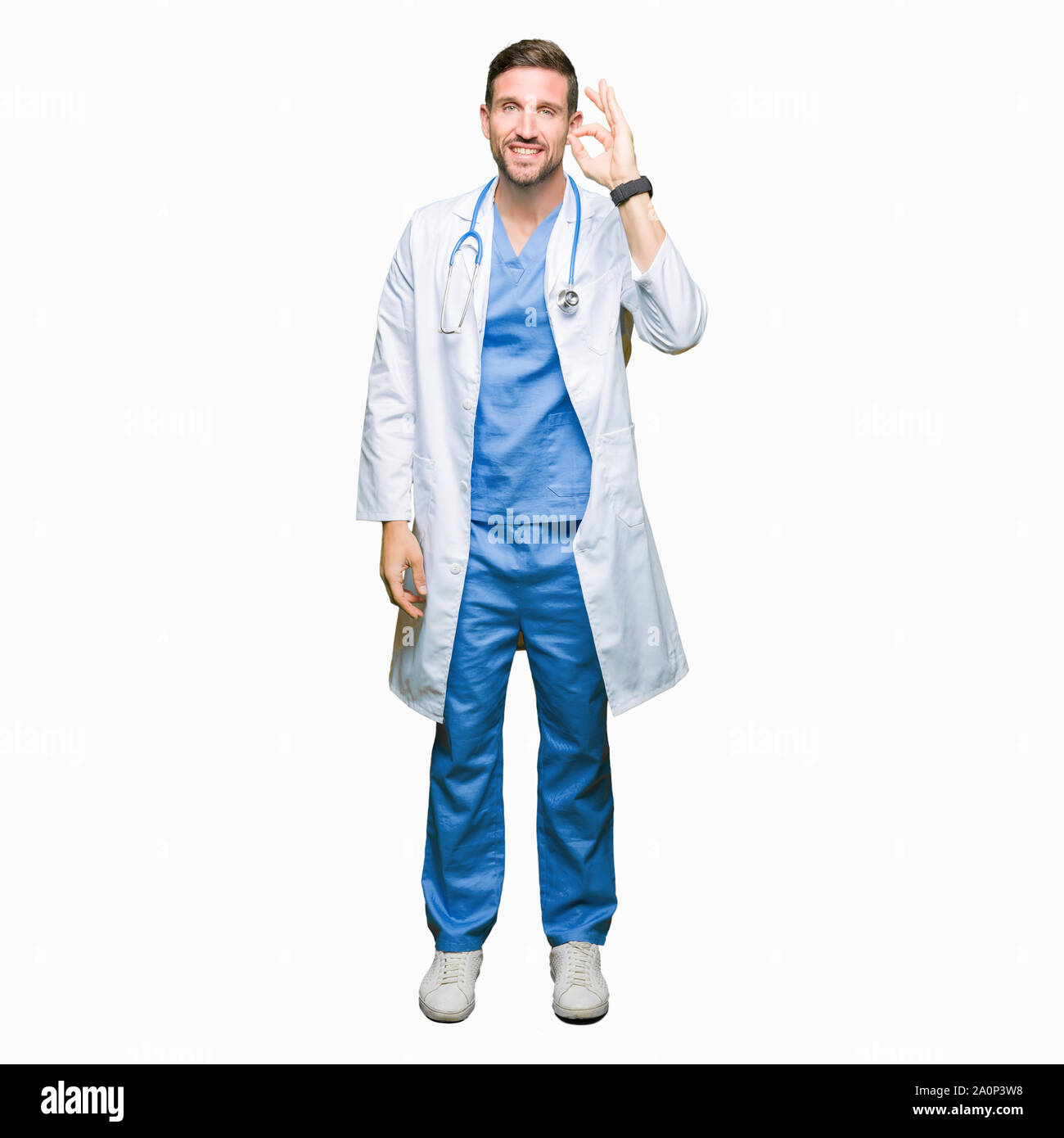 Handsome doctor man wearing medical uniform over isolated background ...