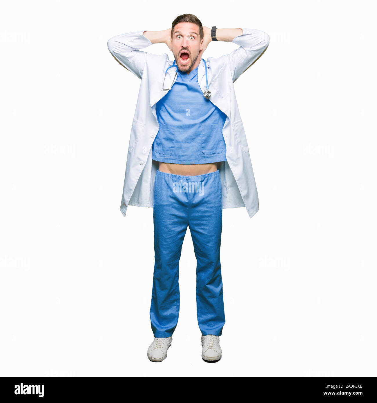 Handsome doctor man wearing medical uniform over isolated background ...