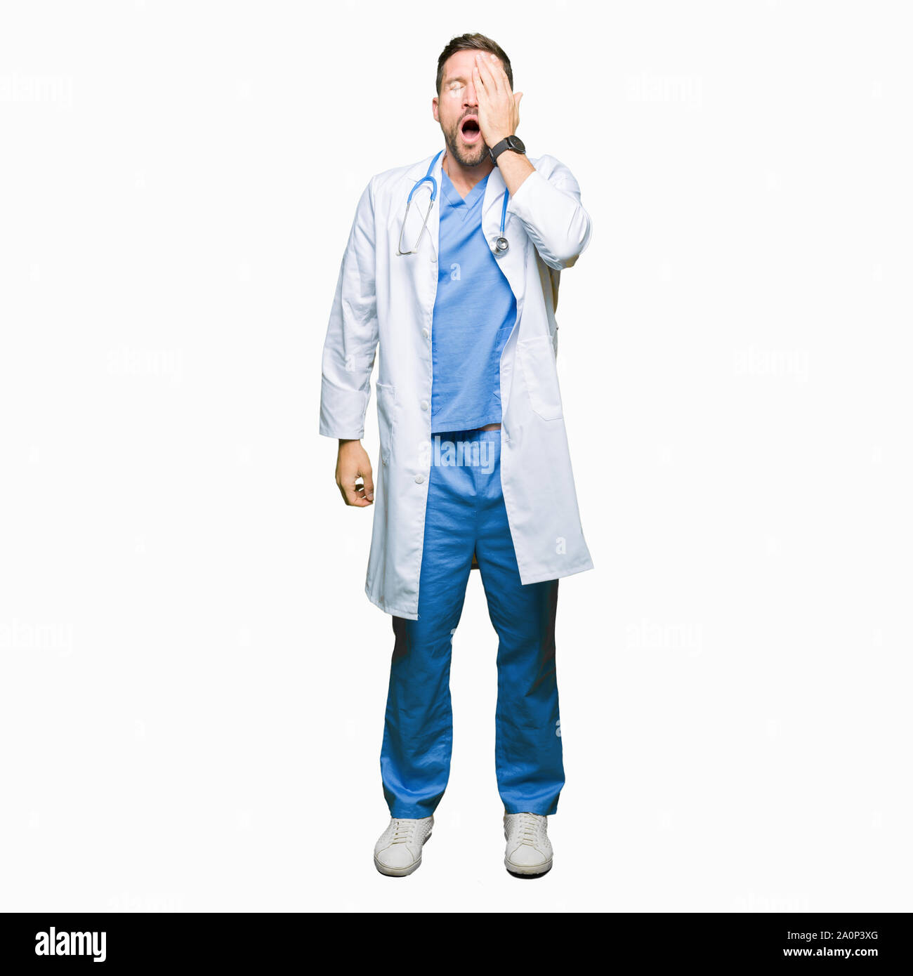 Handsome doctor man wearing medical uniform over isolated background ...