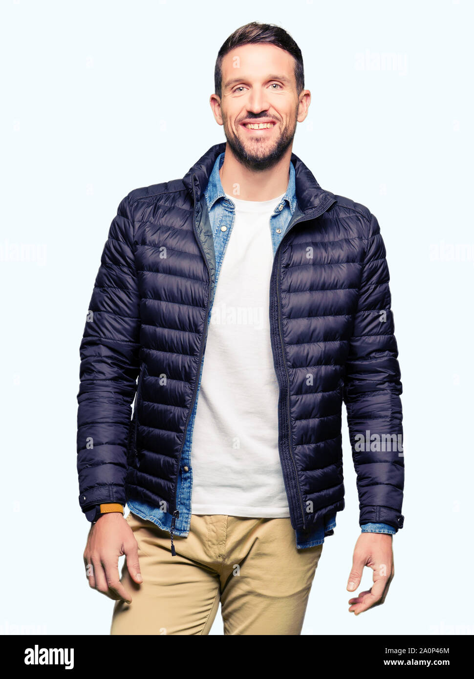 Handsome man wearing winter coat with a happy and cool smile on face ...