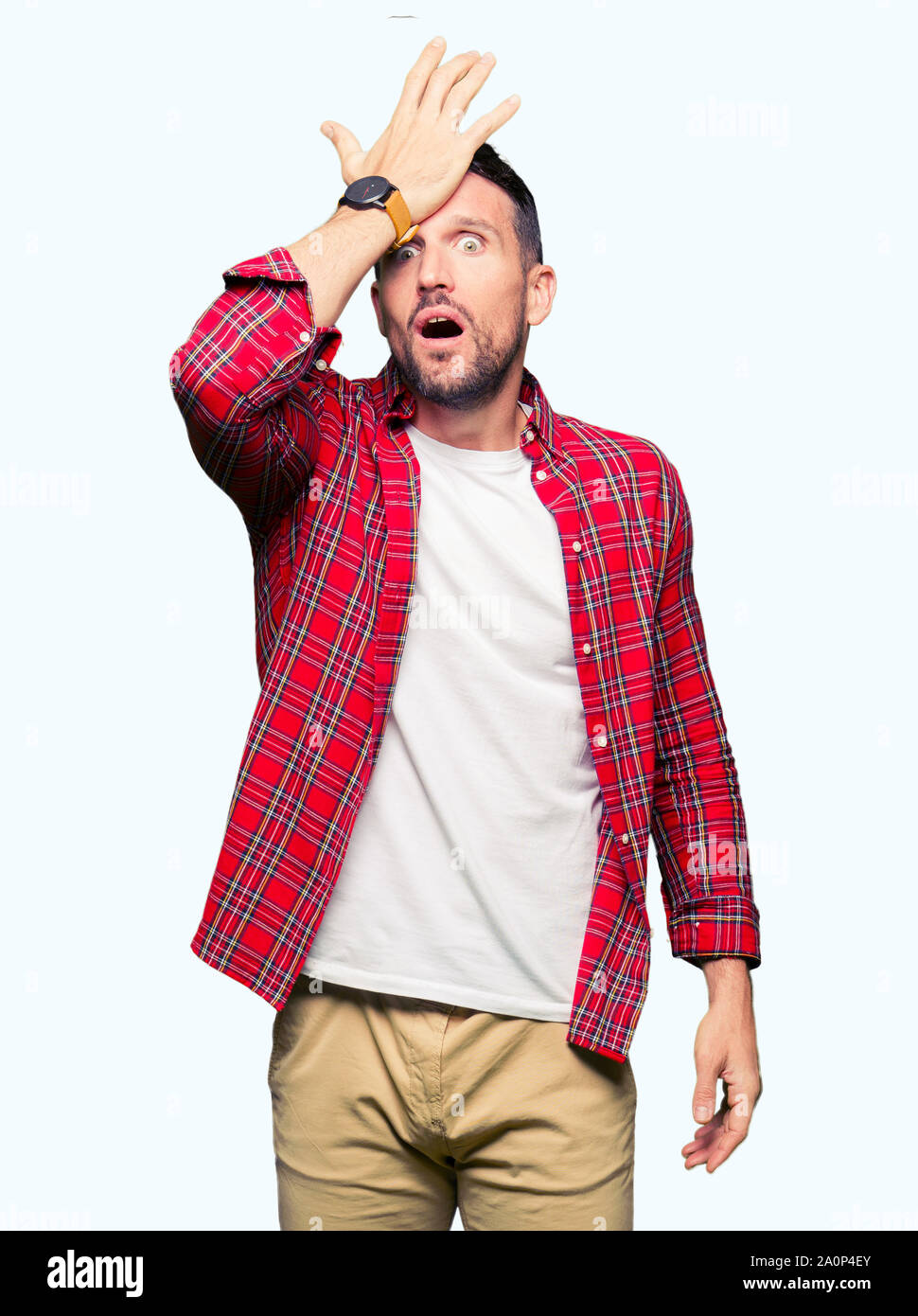 Handsome man wearing casual shirt surprised with hand on head for ...