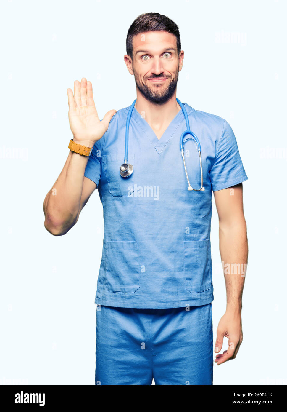 Handsome doctor man wearing medical uniform over isolated background ...