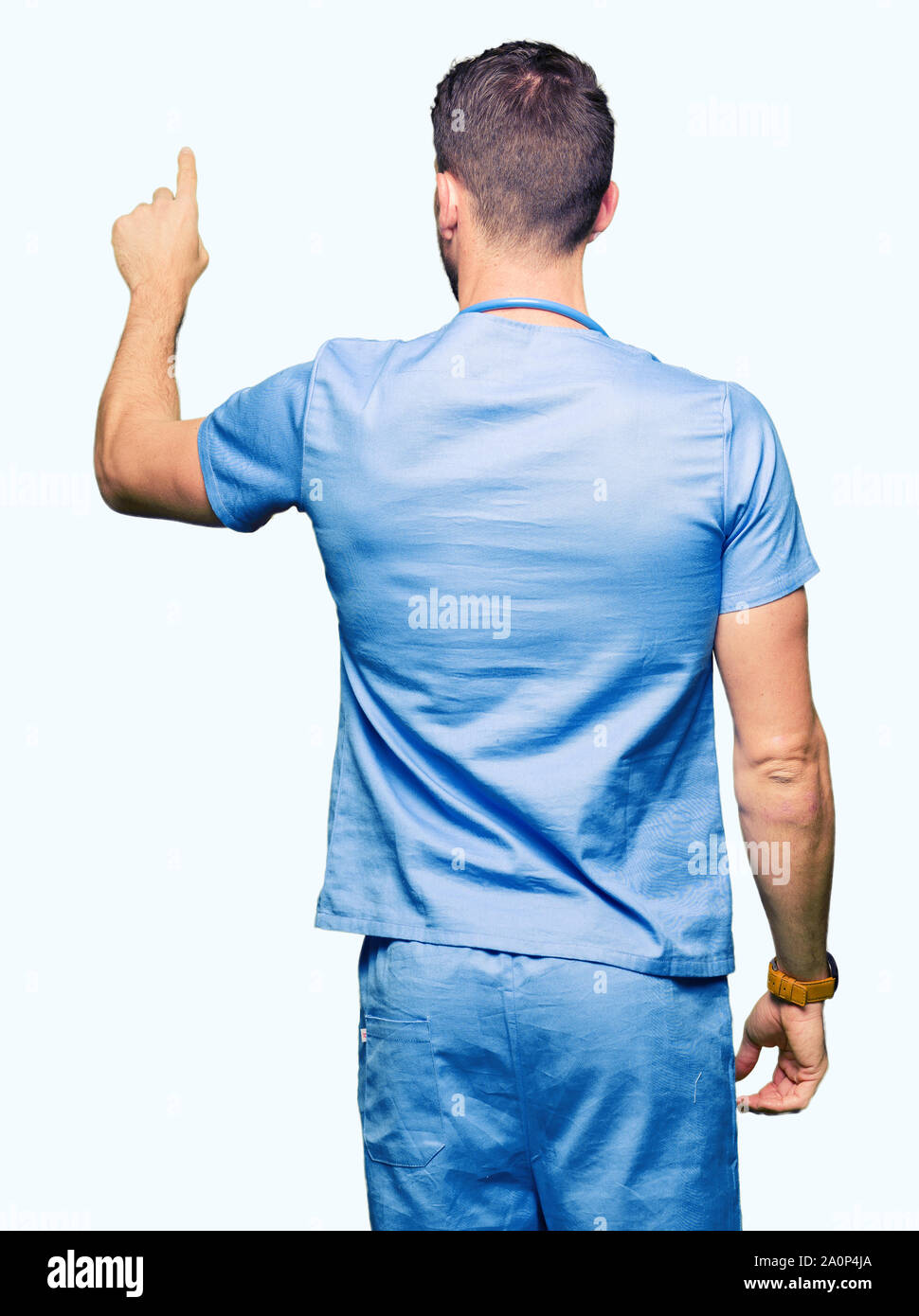 Handsome doctor man wearing medical uniform over isolated background ...