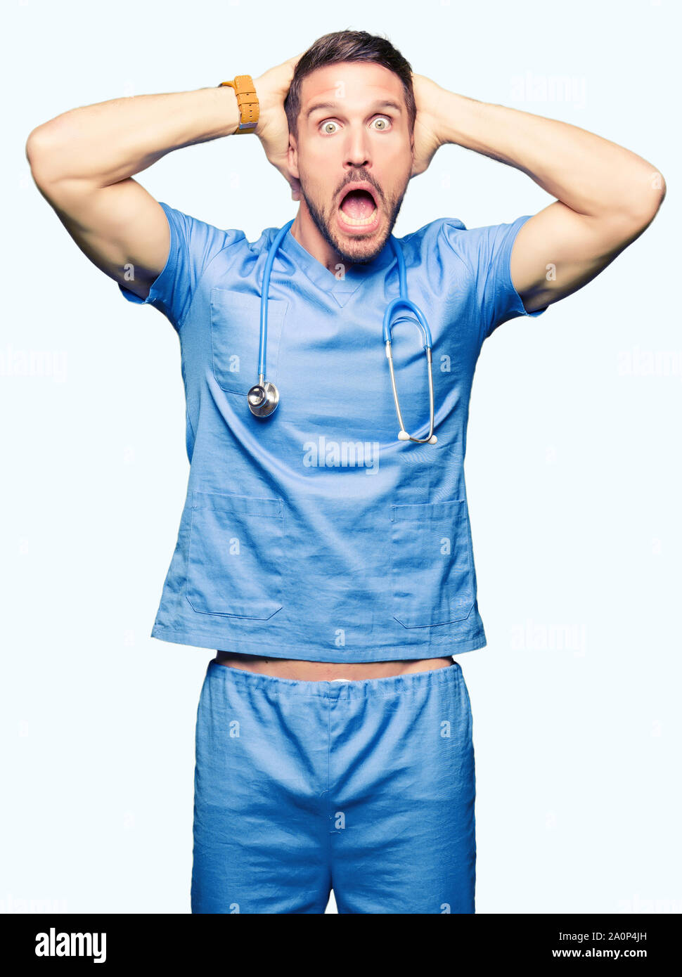 Handsome doctor man wearing medical uniform over isolated background ...
