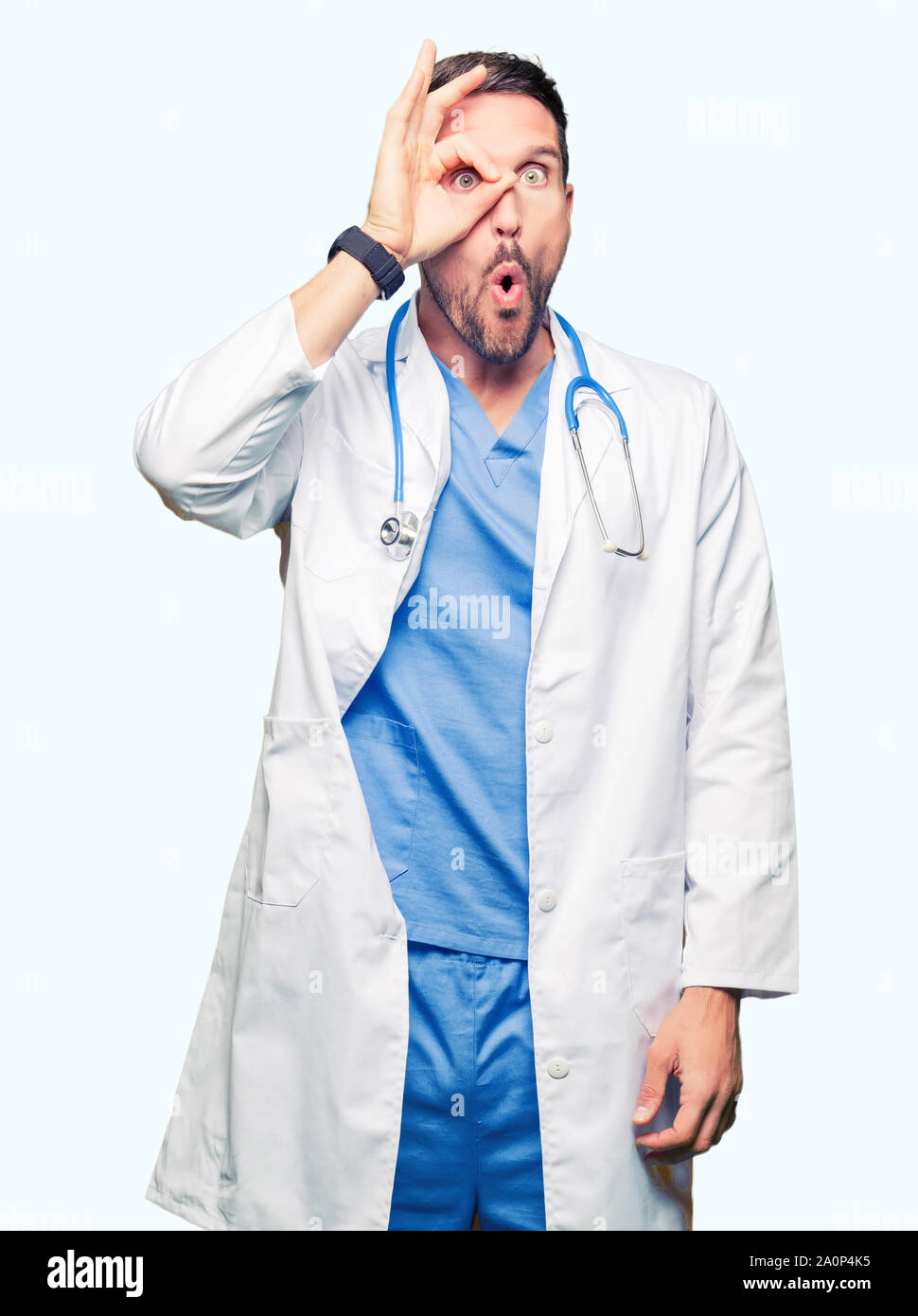 Handsome doctor man wearing medical uniform over isolated background ...