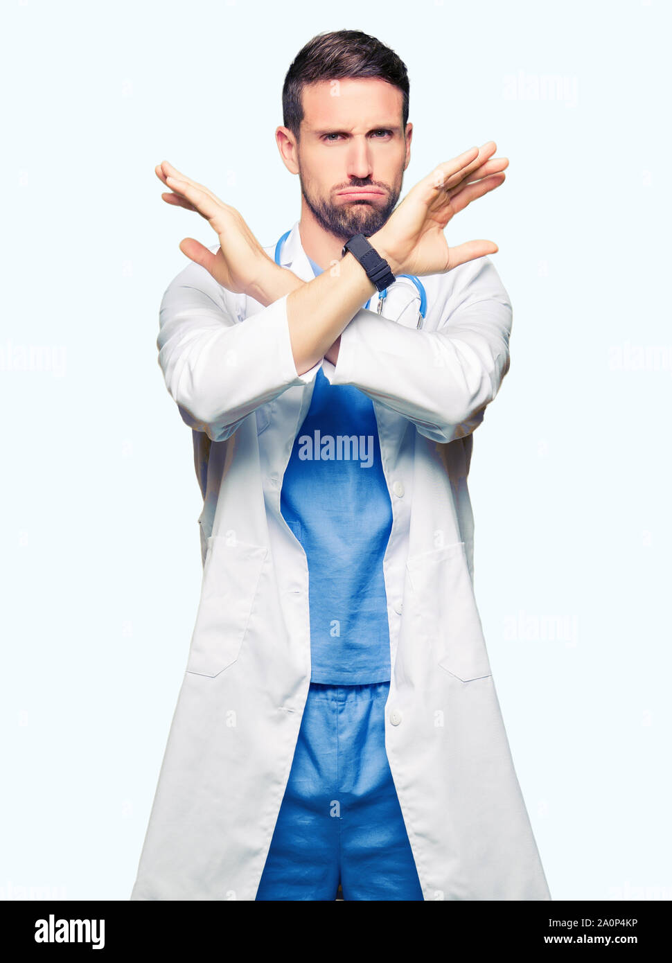 Handsome doctor man wearing medical uniform over isolated background ...