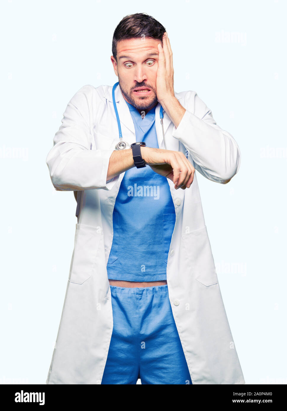 Handsome doctor man wearing medical uniform over isolated background ...