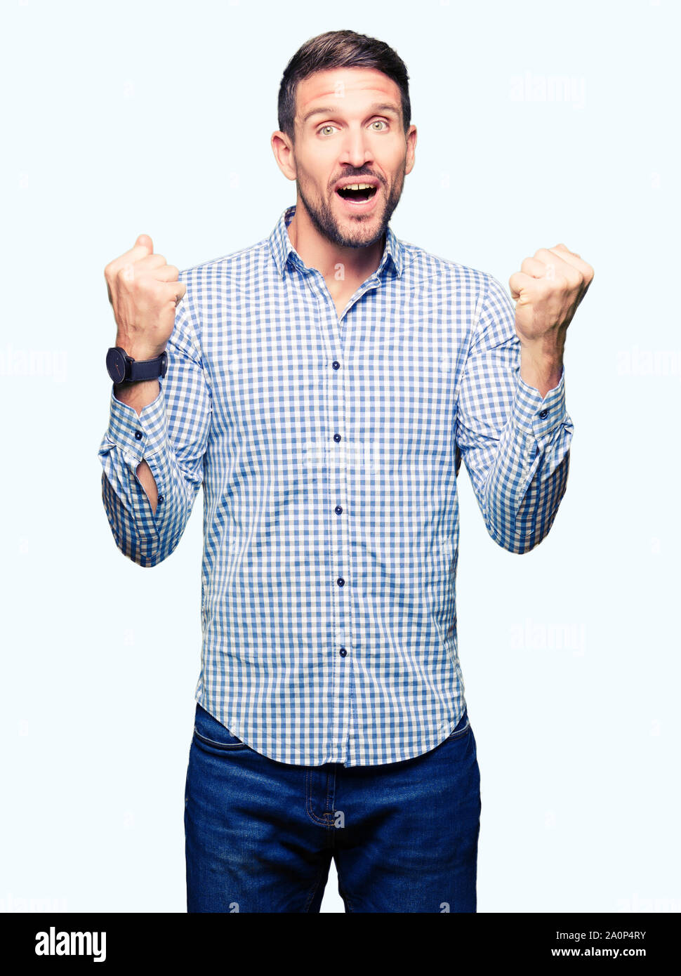 Handsome business man with blue eyes celebrating surprised and amazed ...
