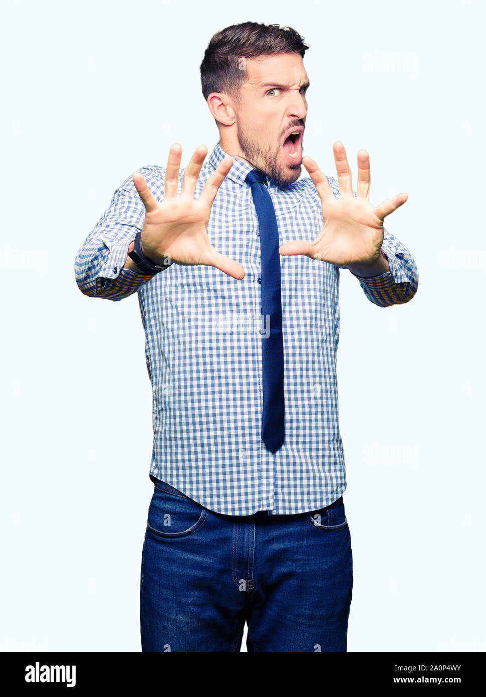 Handsome business man wearing tie afraid and terrified with fear ...