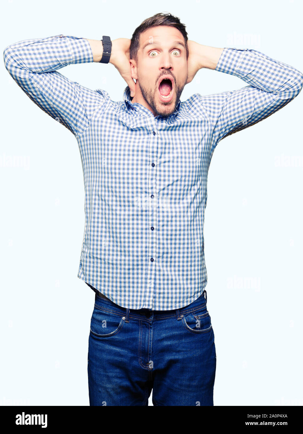 Handsome business man with blue eyes Crazy and scared with hands on ...