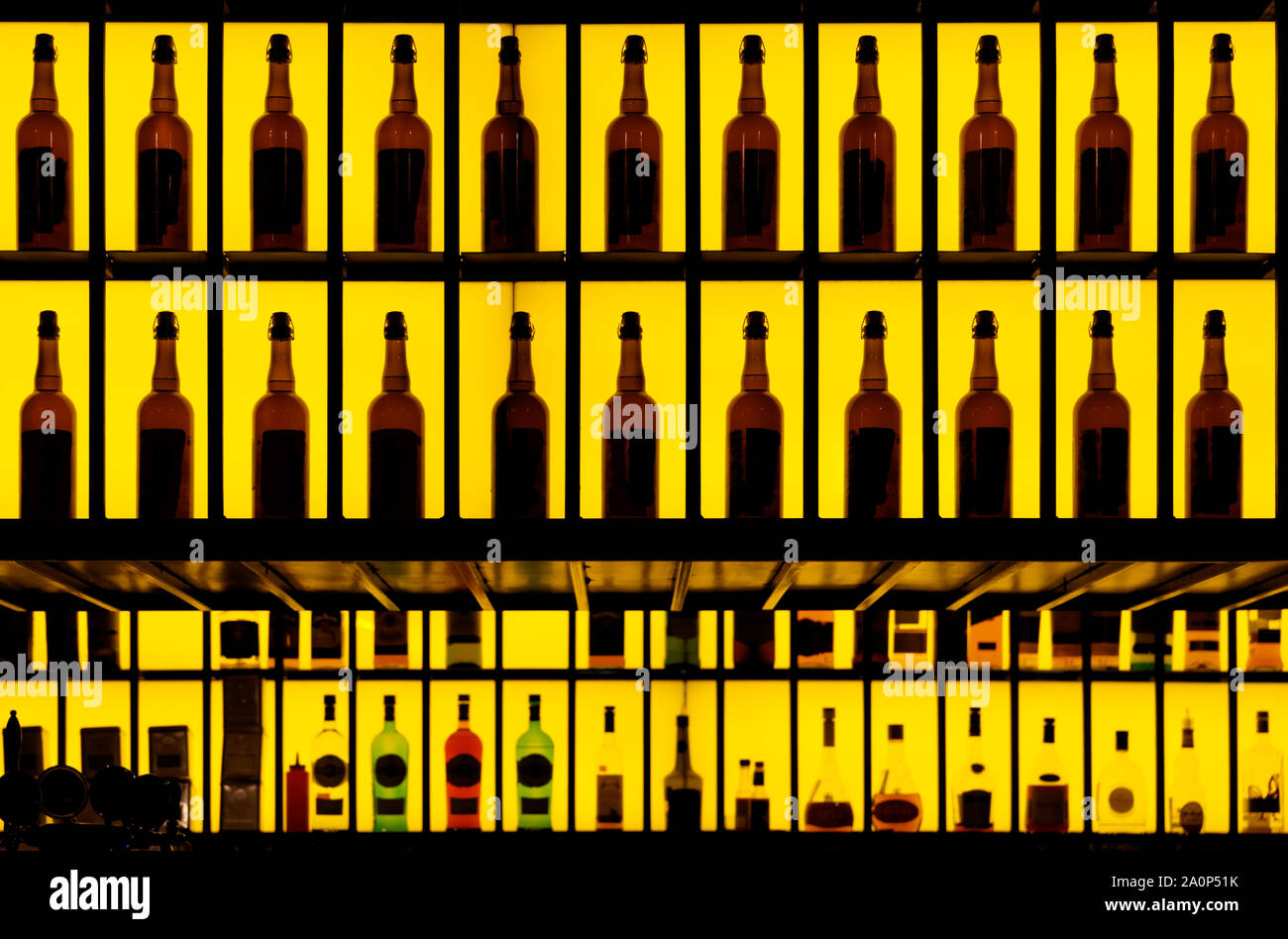 Various alcohol bottles in a bar, back yellow lighting Stock Photo - Alamy