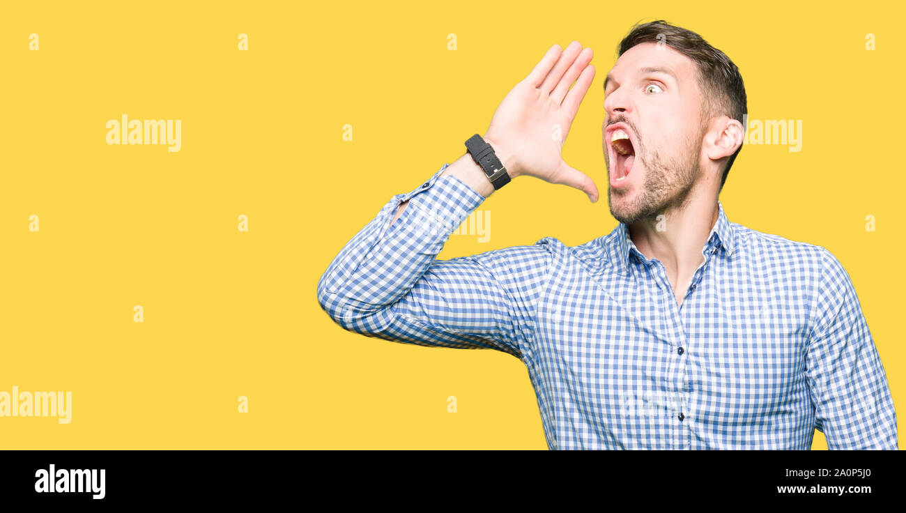 Handsome business man with blue eyes shouting and screaming loud to ...