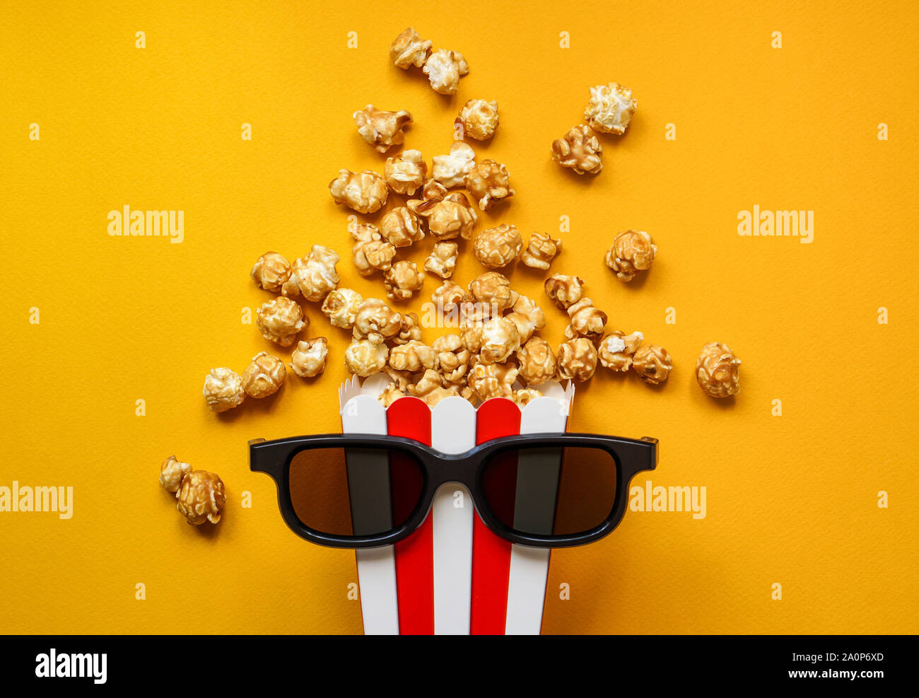 Popcorn in a red and white cardboard box with glasses for a 3D movie on ...