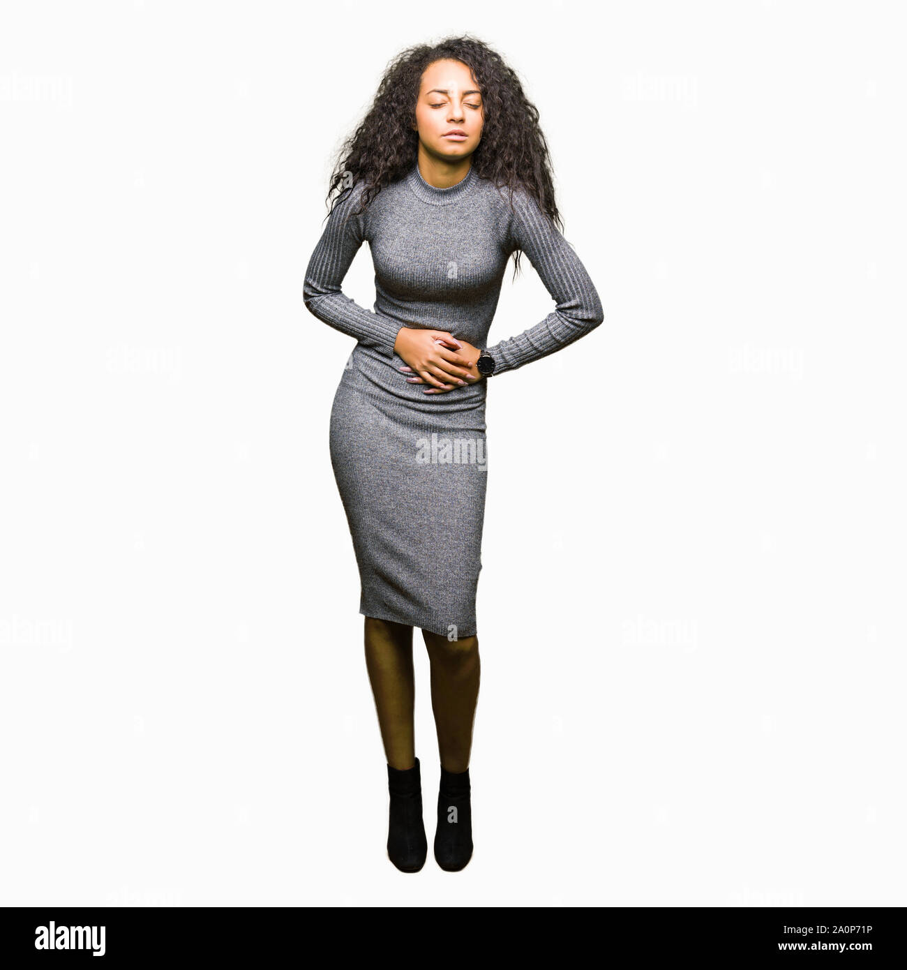 Young beautiful girl with curly hair with hand on stomach because ...