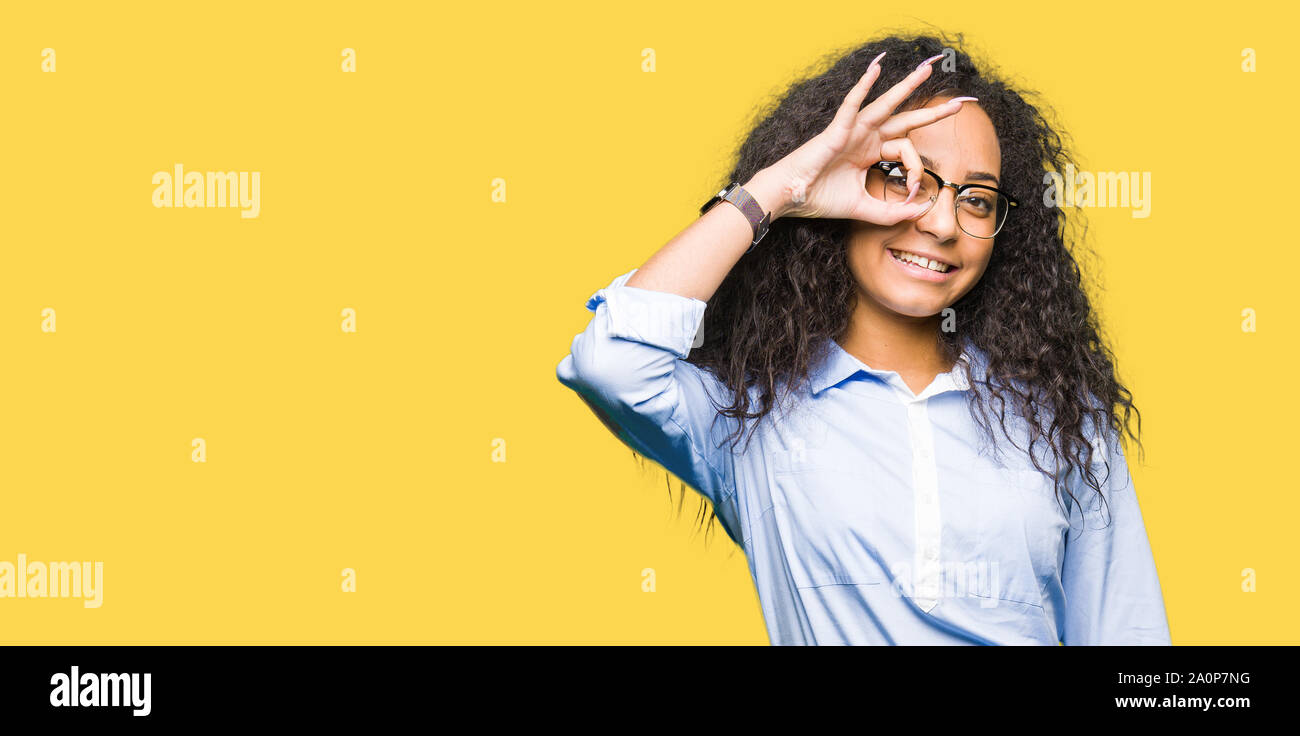Young beautiful business girl with curly hair wearing glasses doing ok ...