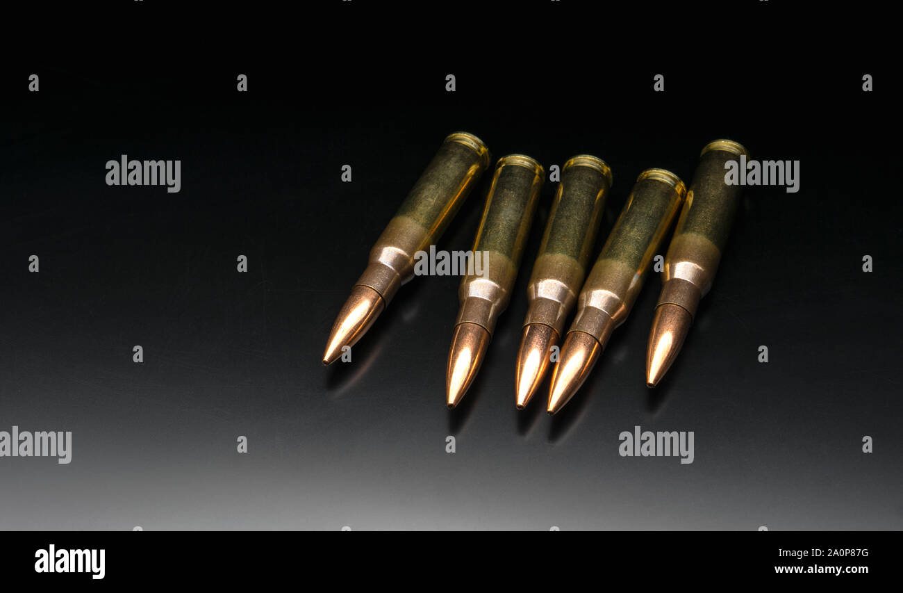 Bullet isolated on black background with reflexion. Rifle bullets close ...