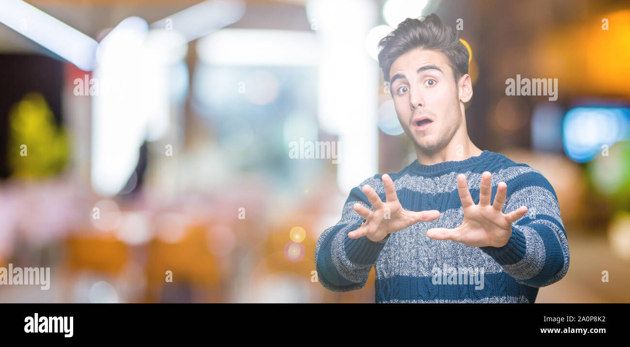 Young handsome man over isolated background afraid and terrified with ...