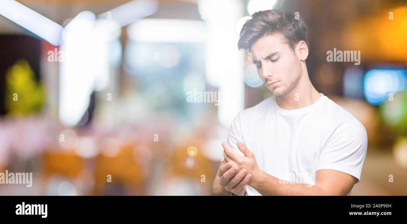 Young handsome man wearing white t-shirt over isolated background ...