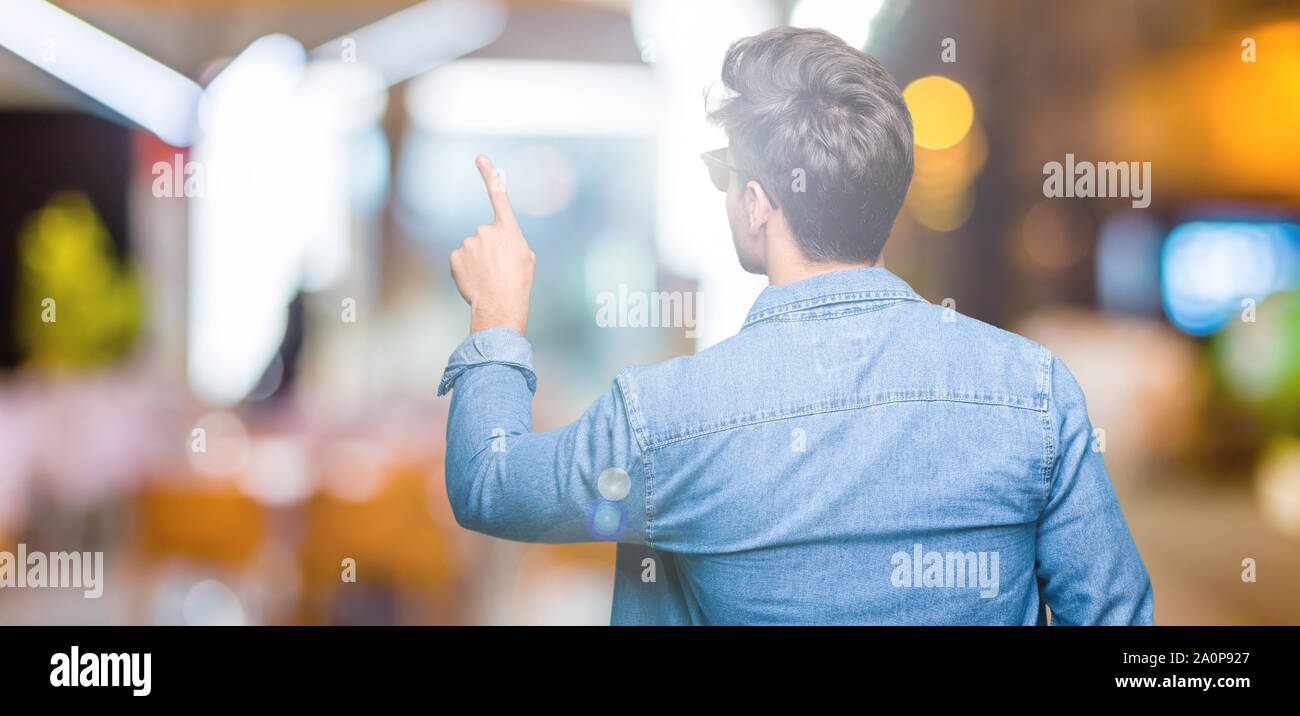 Young handsome man wearing sunglasses over isolated background Posing ...