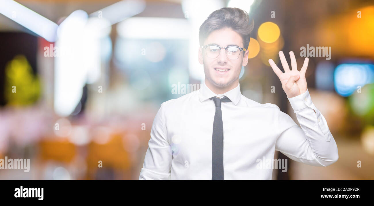 Young business man wearing glasses over isolated background showing and ...