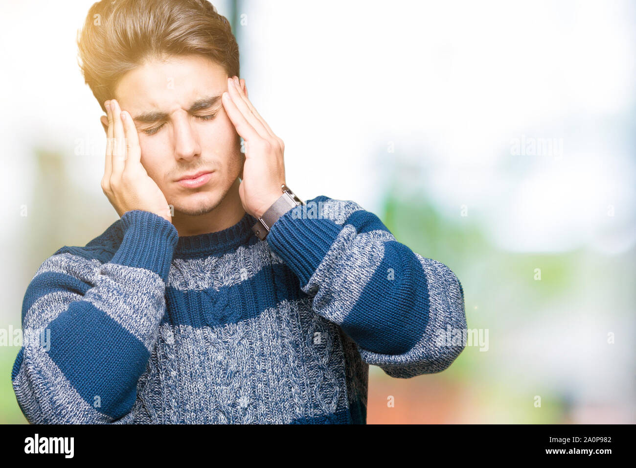 Young handsome man over isolated background with hand on head for pain ...