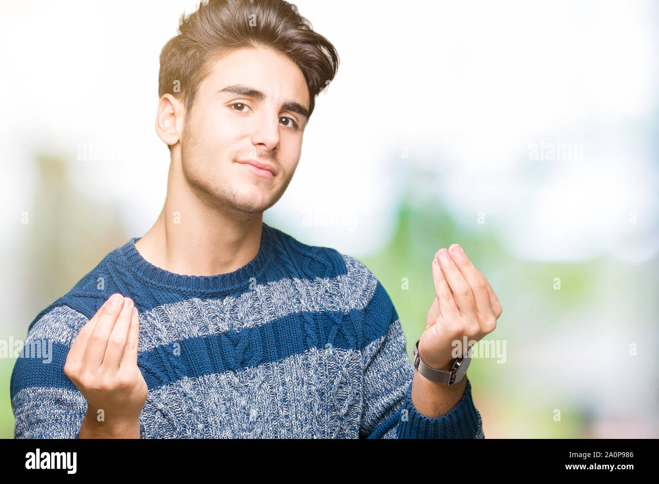 Young handsome man over isolated background Doing money gesture with ...