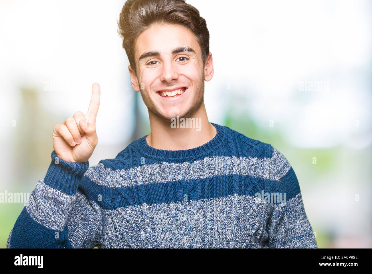 Young handsome man over isolated background showing and pointing up ...