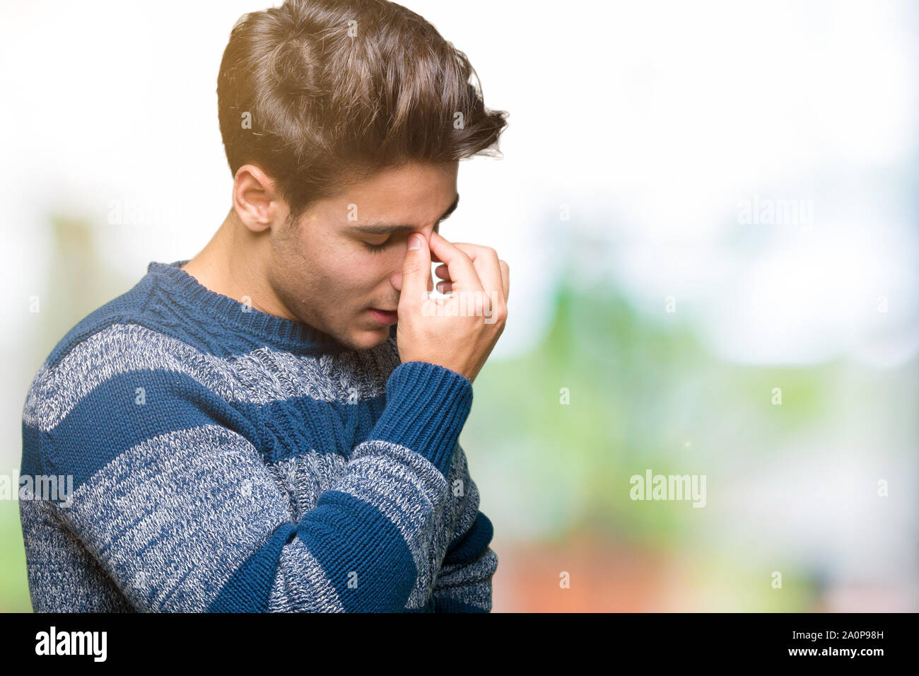 Young handsome man over isolated background tired rubbing nose and eyes ...