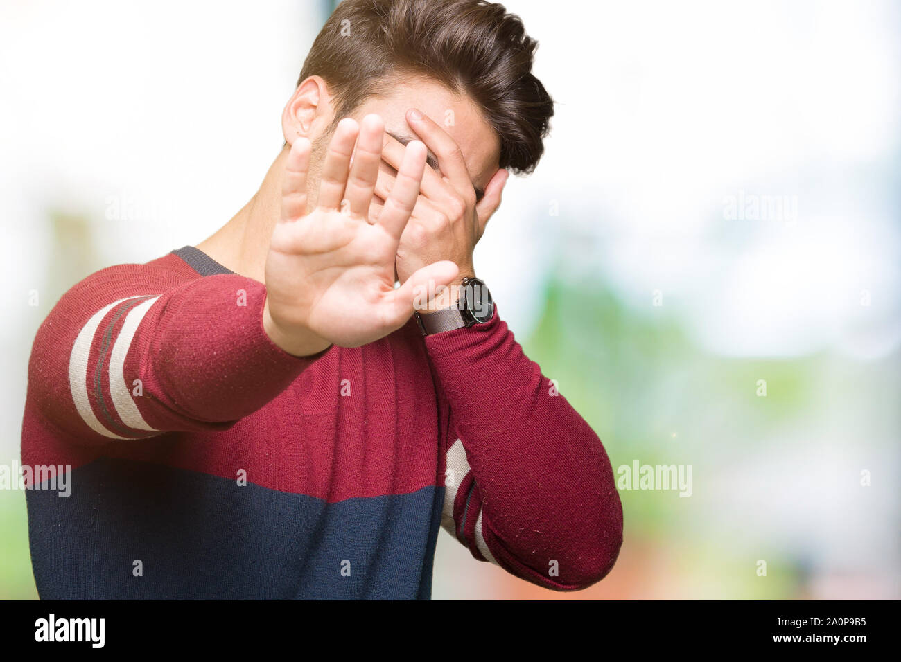 Young handsome man over isolated background covering eyes with hands ...