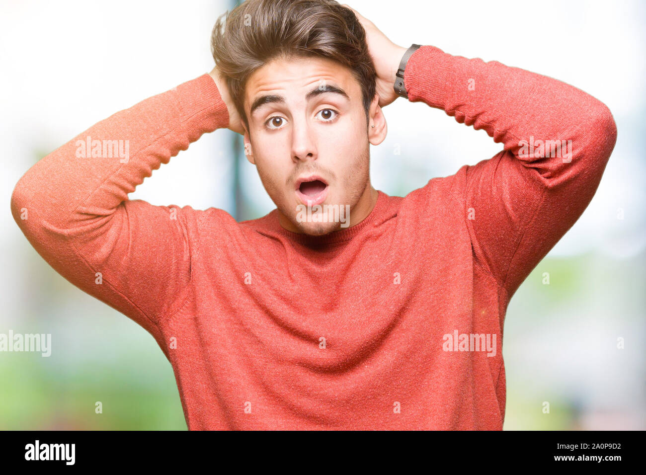 Young handsome man over isolated background Crazy and scared with hands ...