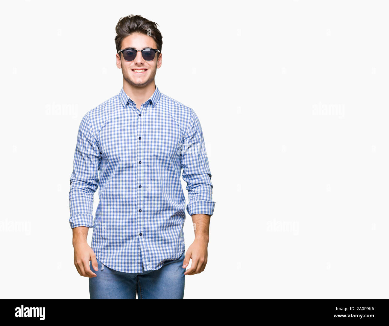 Young handsome man wearing sunglasses over isolated background with a ...