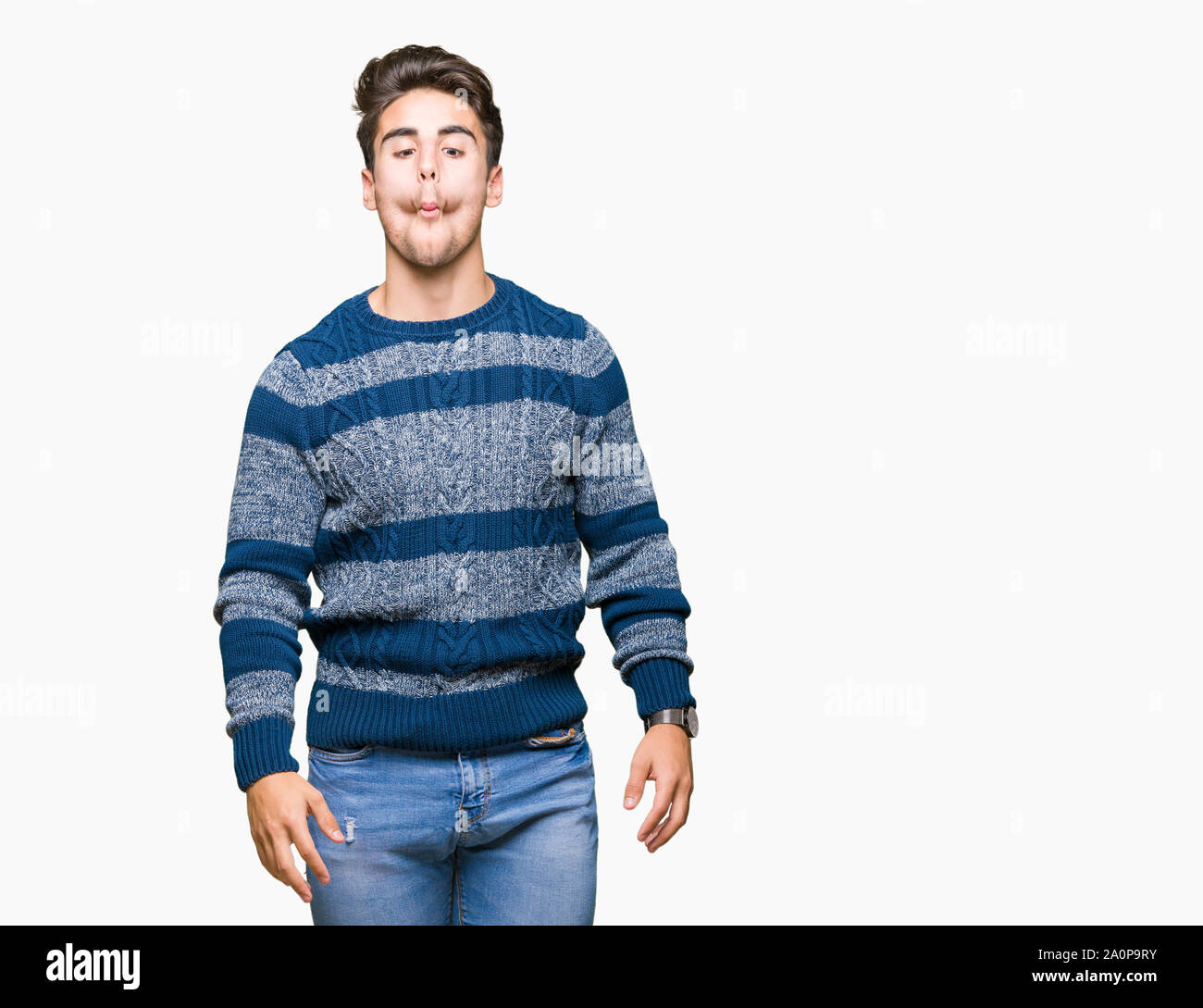 Young handsome man over isolated background making fish face with lips ...