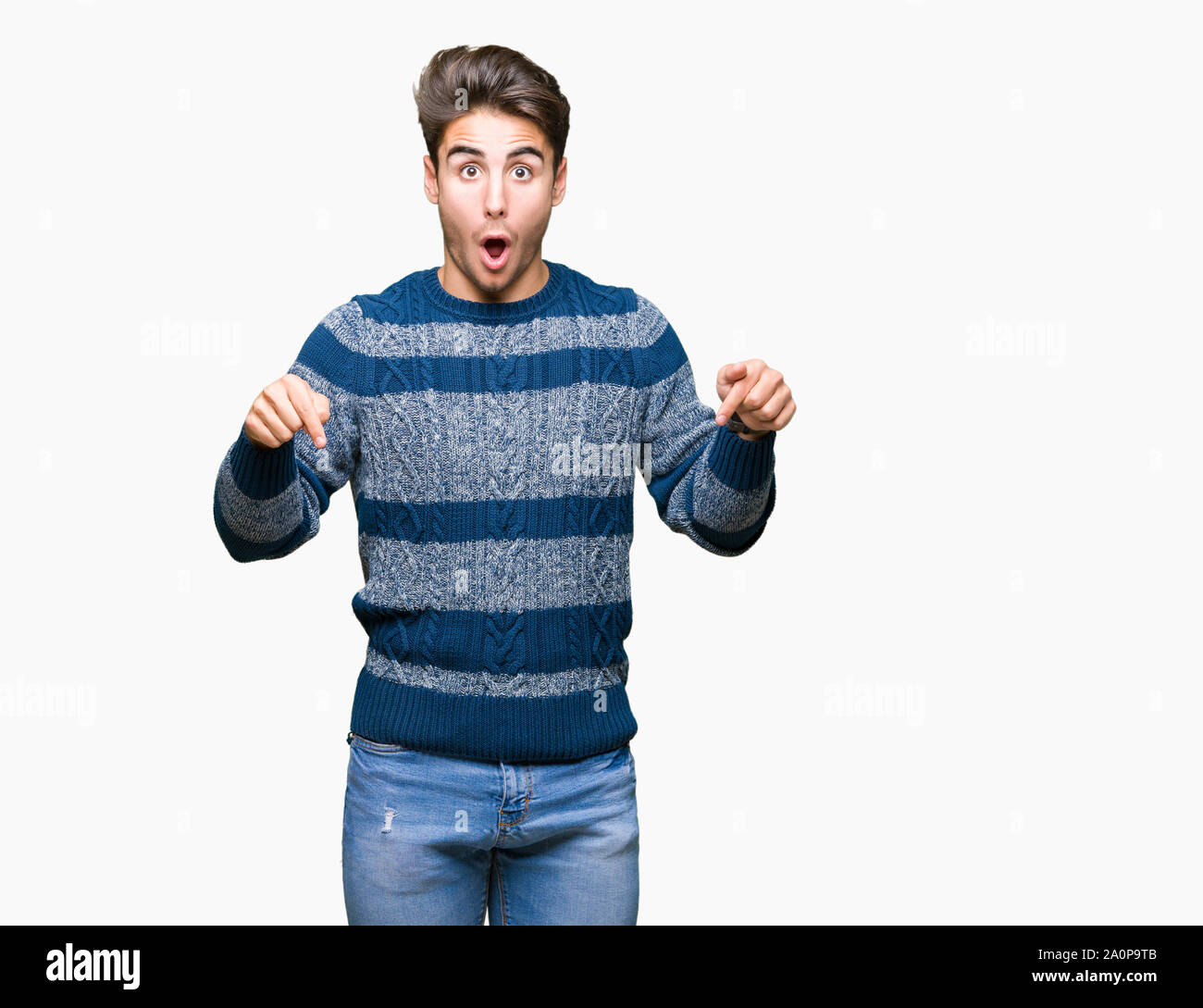 Young handsome man over isolated background Pointing down with fingers ...