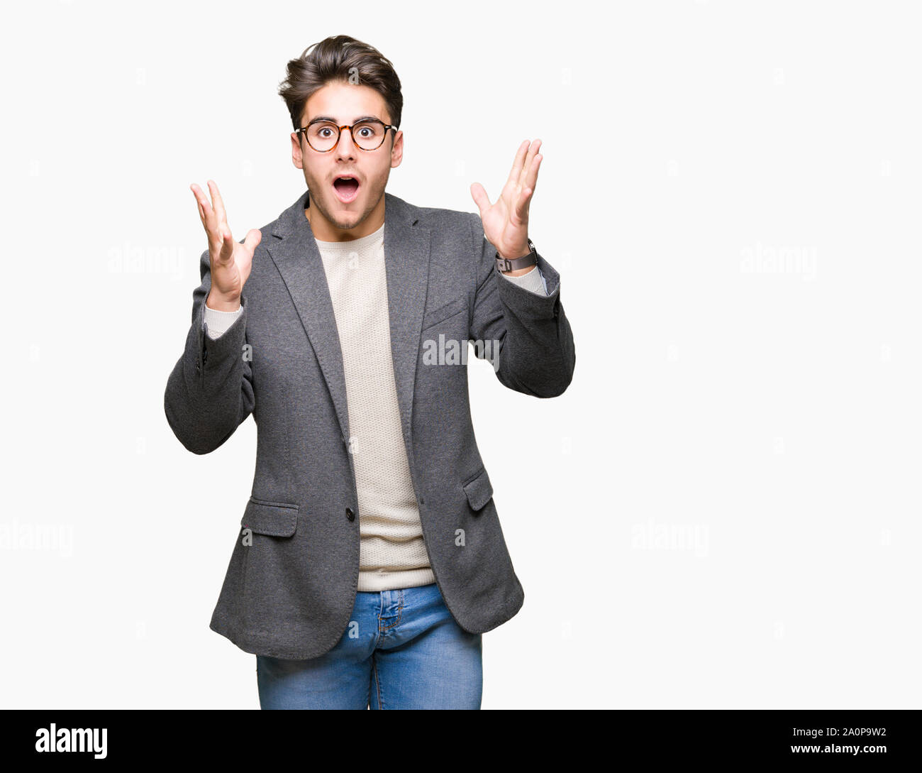 Young business man wearing glasses over isolated background celebrating ...
