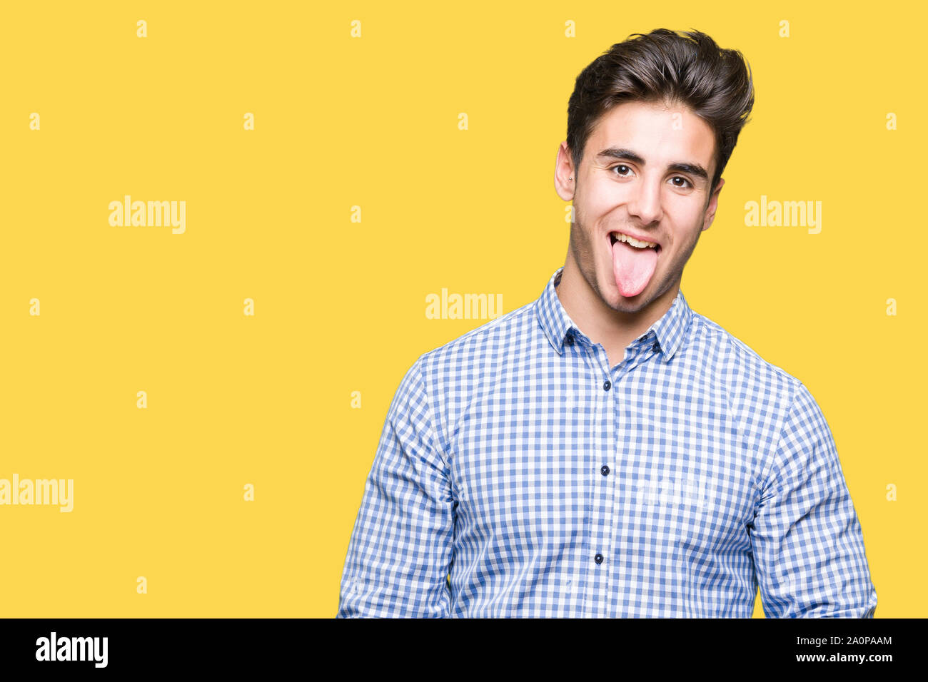 Young handsome business man over isolated background sticking tongue ...