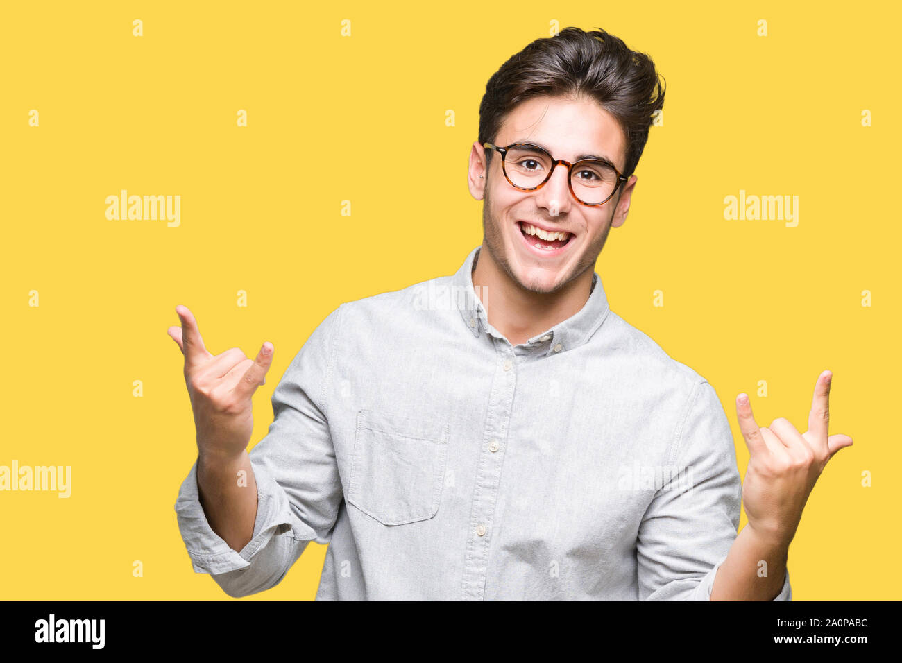 Young handsome man wearing glasses over isolated background shouting ...