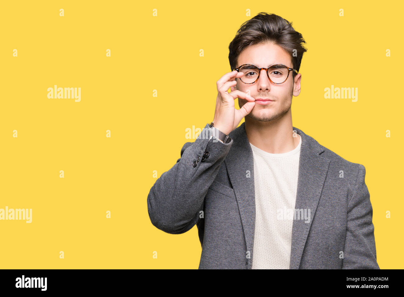 Young business man wearing glasses over isolated background mouth and ...
