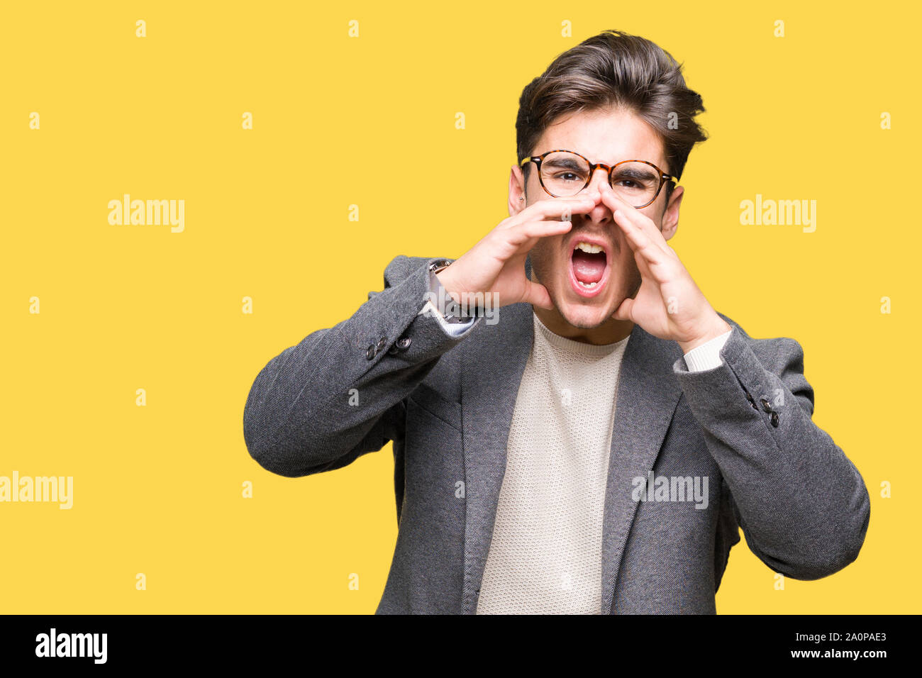 Young business man wearing glasses over isolated background Shouting ...