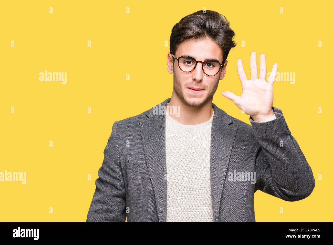 Young business man wearing glasses over isolated background showing and ...