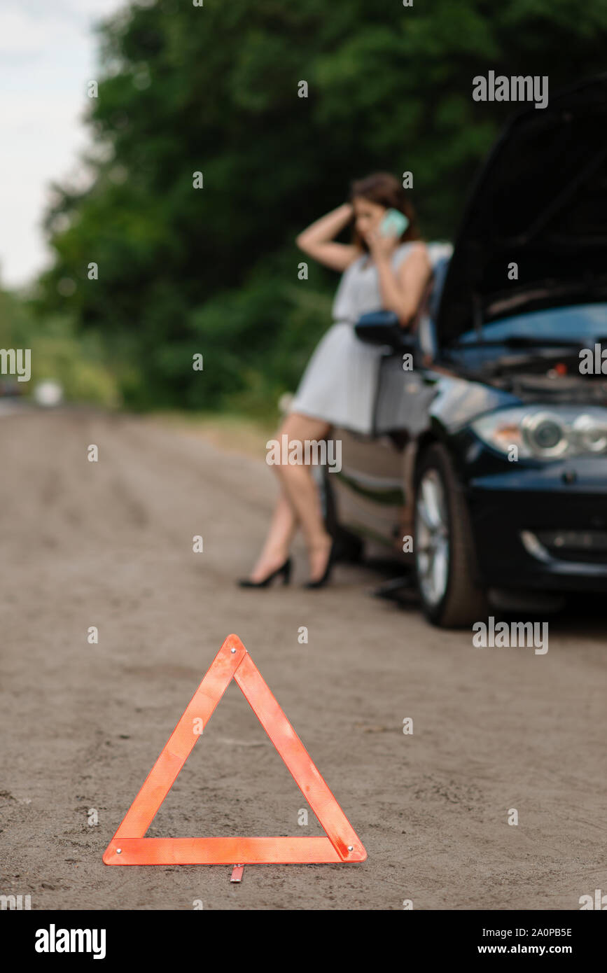 Breakdown, emergency sign, woman calling for help Stock Photo - Alamy