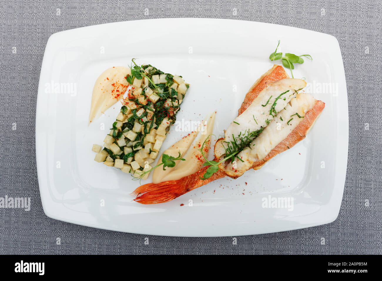 Red snapper fillet and fried celery root with potato mash Stock Photo ...