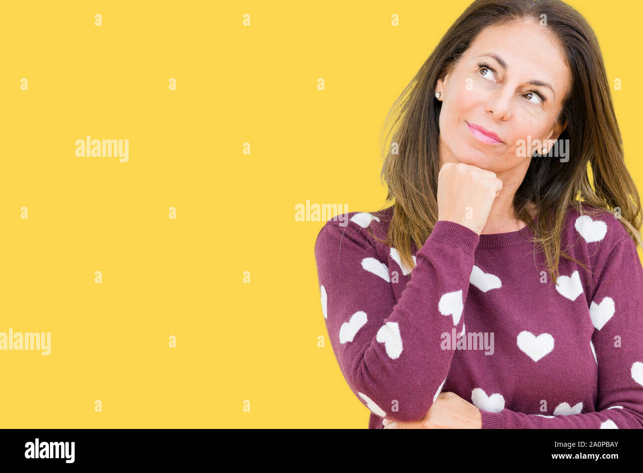 Beautiful middle age woman wearing hearts sweater over isolated ...