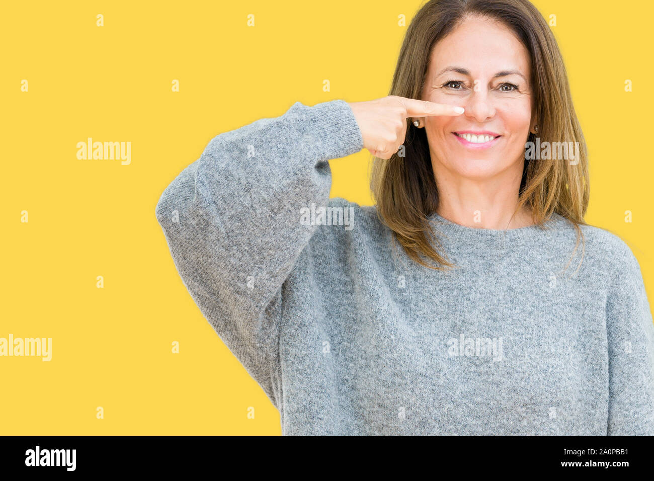 Beautiful middle age woman wearing winter sweater over isolated ...