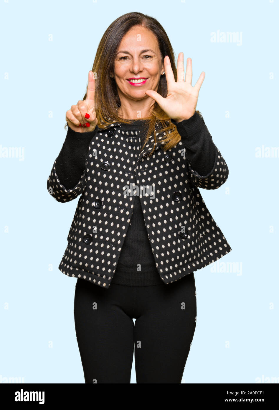Beautiful middle age woman wearing fashion jacket showing and pointing ...