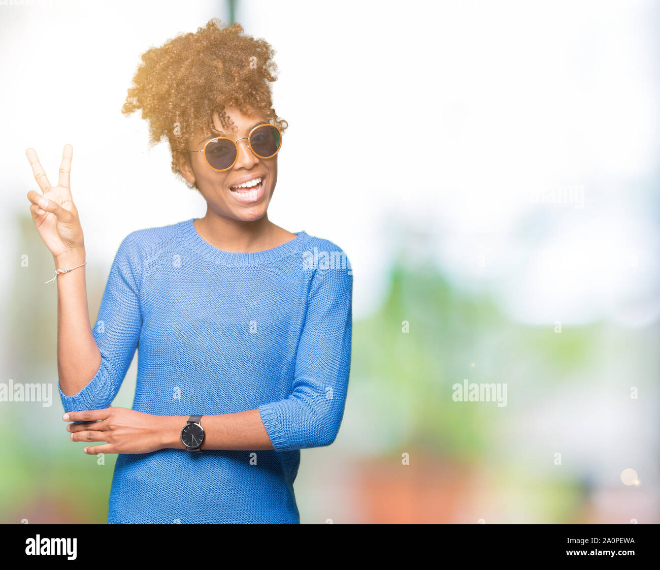 Beautiful young african american woman wearing sunglasses over isolated ...