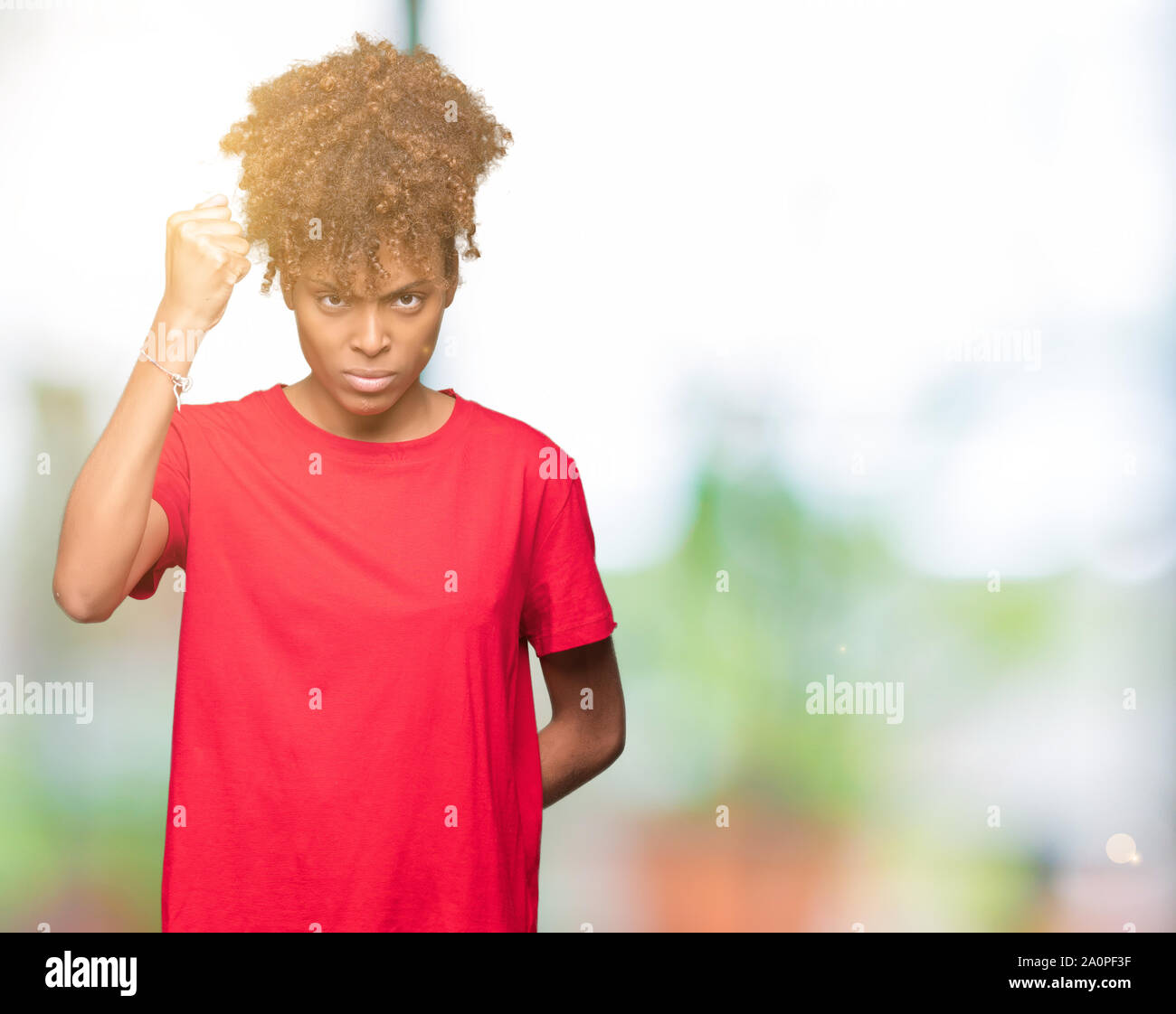 Beautiful young african american woman over isolated background angry ...