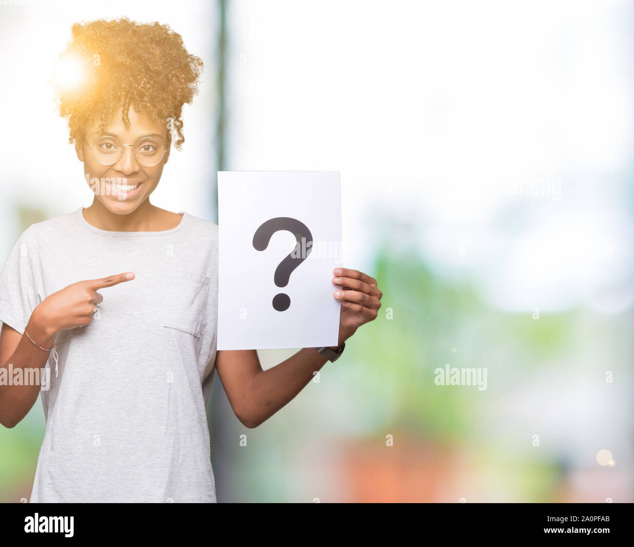 Young african american woman holding paper with question mark over ...